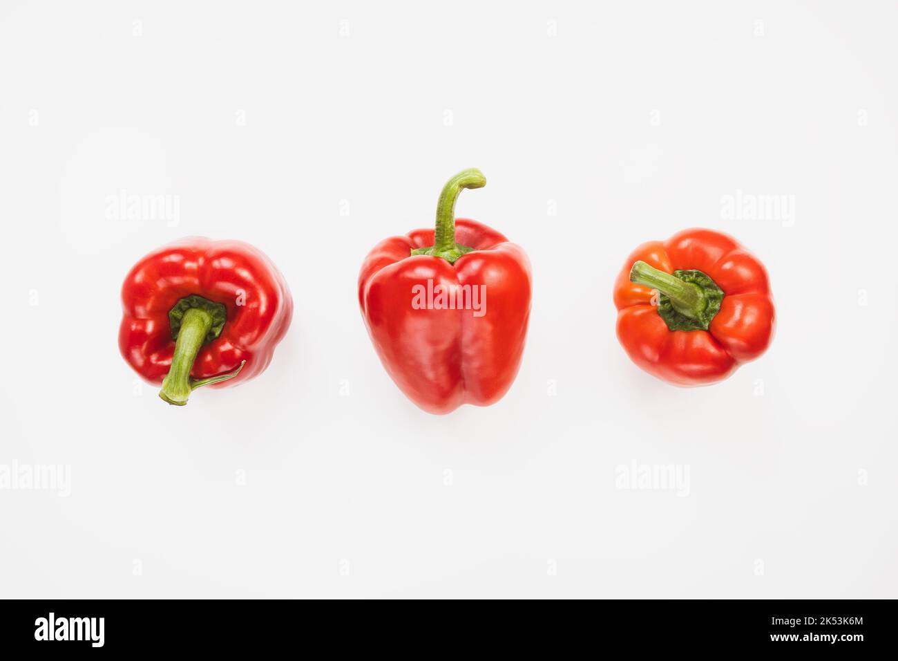 Three fresh ripe sweet red bell peppers on white background. Healthy ...