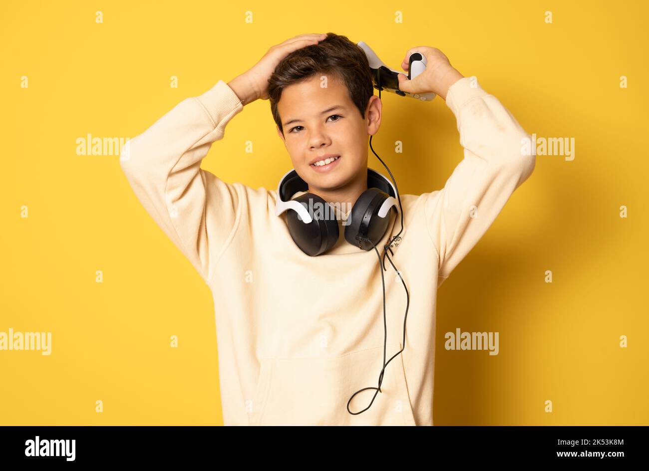 A young child having fun playing video games standing isolated over ...