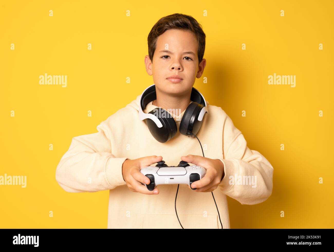 A young child having fun playing video games standing isolated over ...