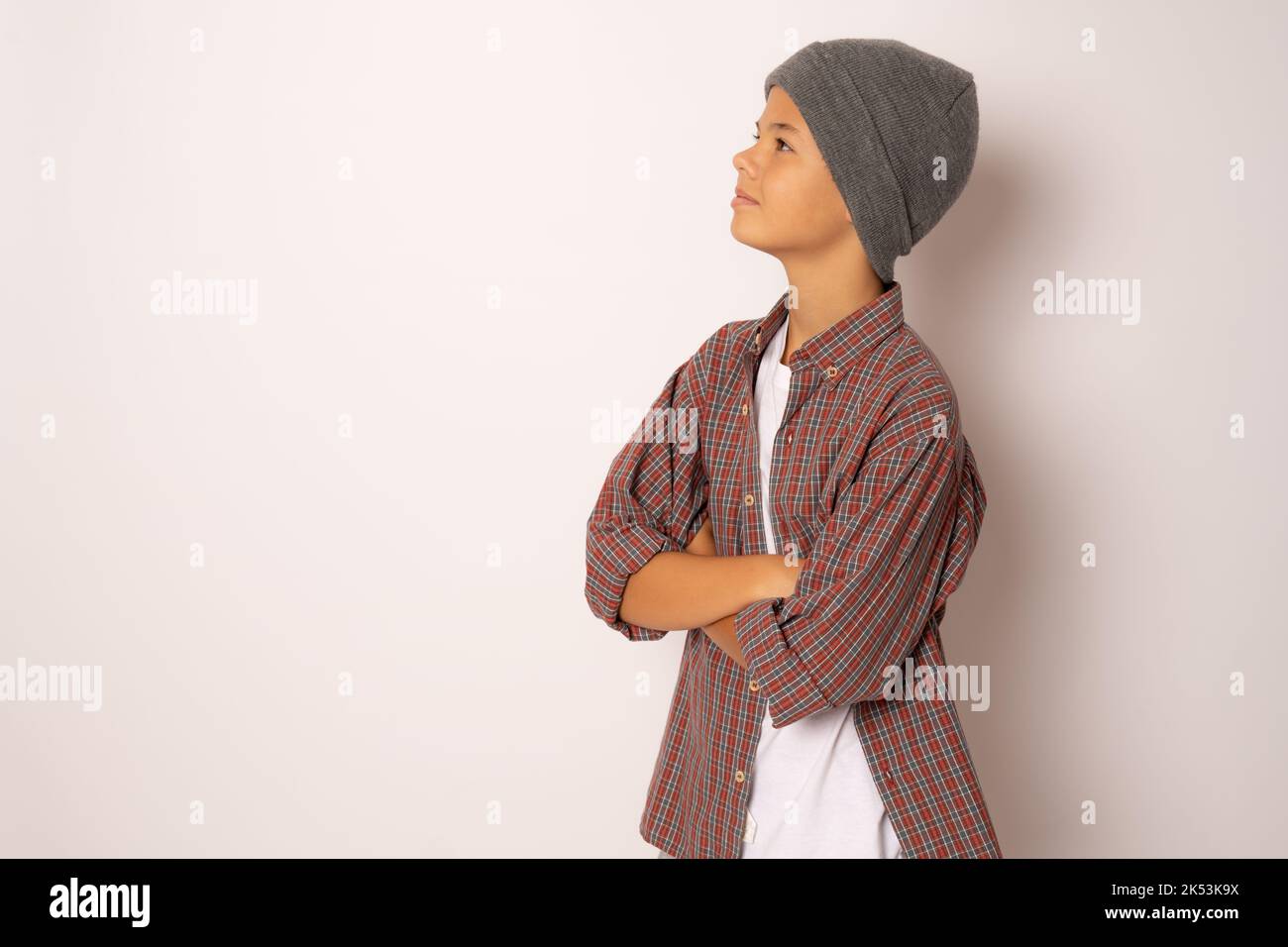 Side view portrait of handsome child boy wearing winter hat standing ...
