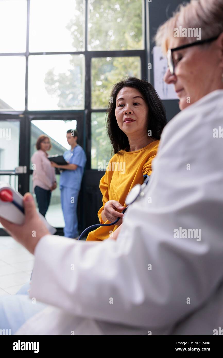 Senior doctor measuring hypertension and blood pressure to do heart ...