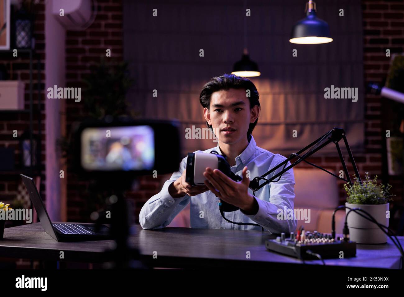 Asian freelancer filming product review with vr glasses, broadcasting ...