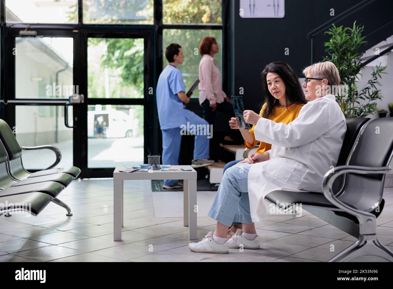 Asian patient analyzing radiography scan with physician specialist in ...