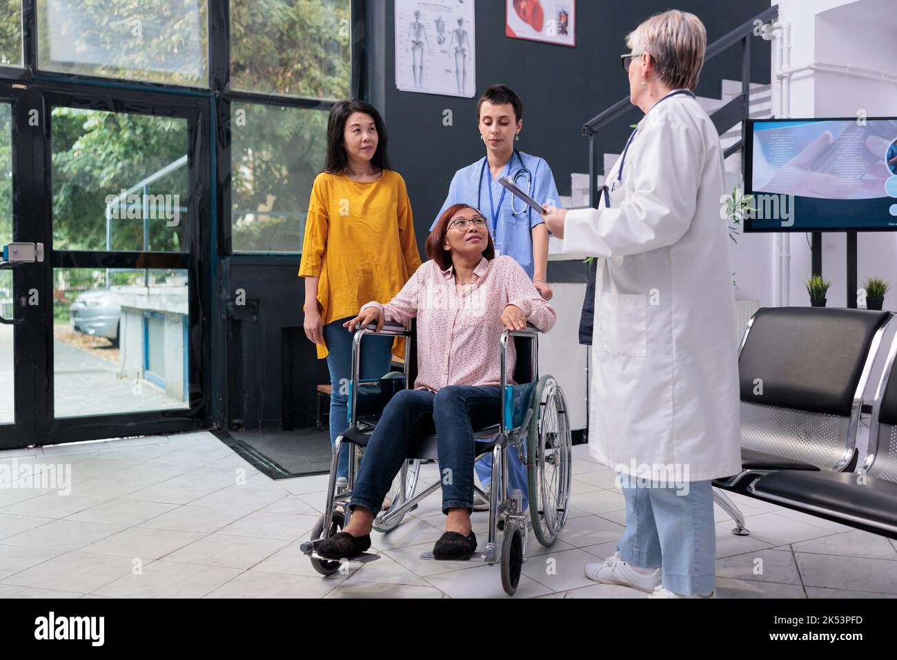 Medical staff talking with injured patient before medical consultation ...