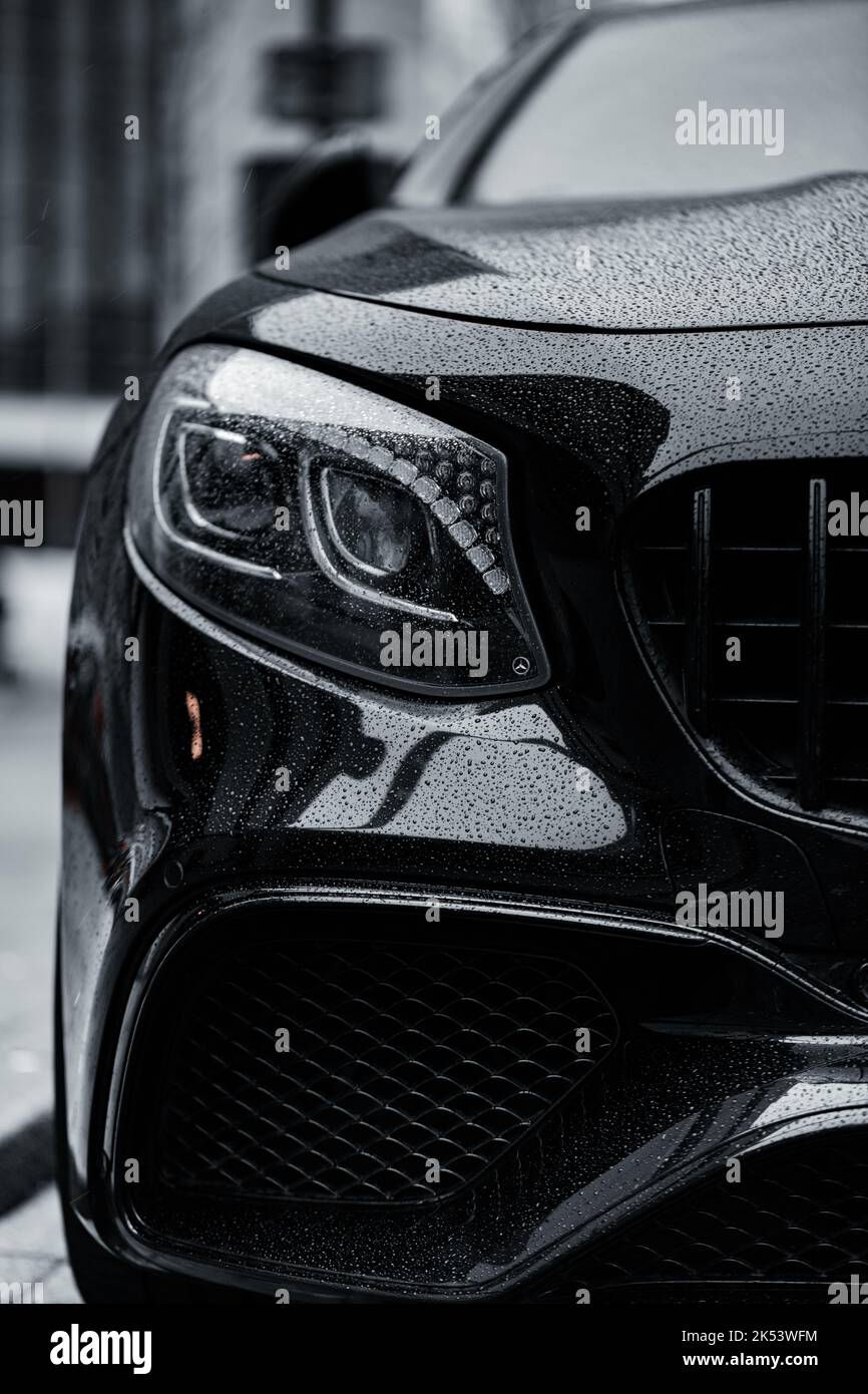 A vertical greyscale shot of a black car front Stock Photo - Alamy