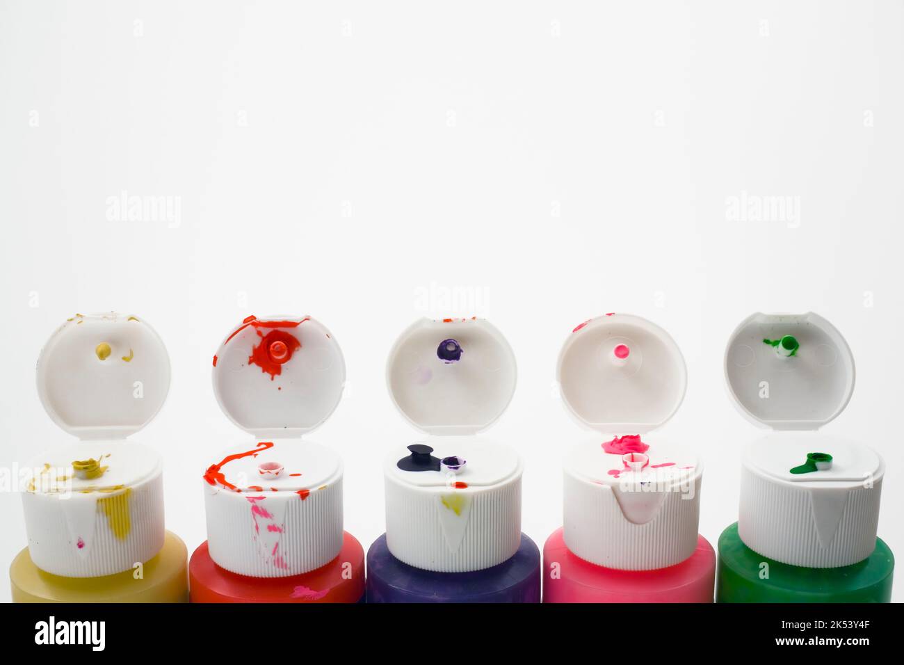 Opened caps on plastic paint bottles against white background Stock ...