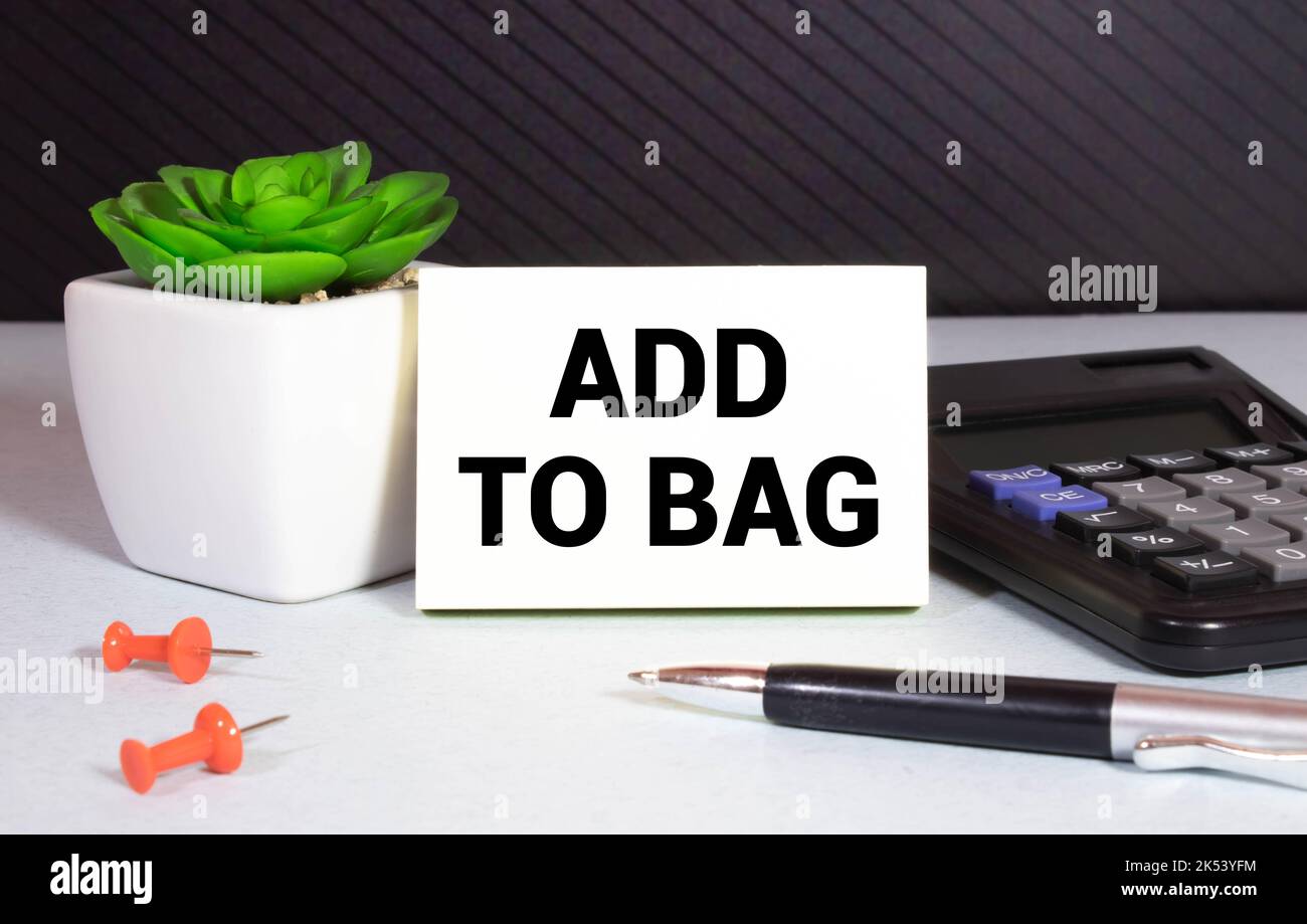 Hand holds a phone with the inscription ADD TO BAG on the red screen ...