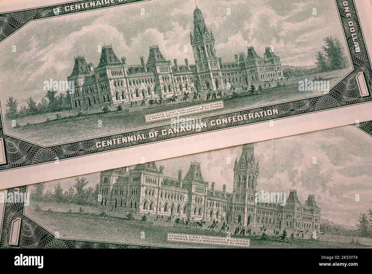 Close-up of details on the reverse side of two Canadian centennial one ...