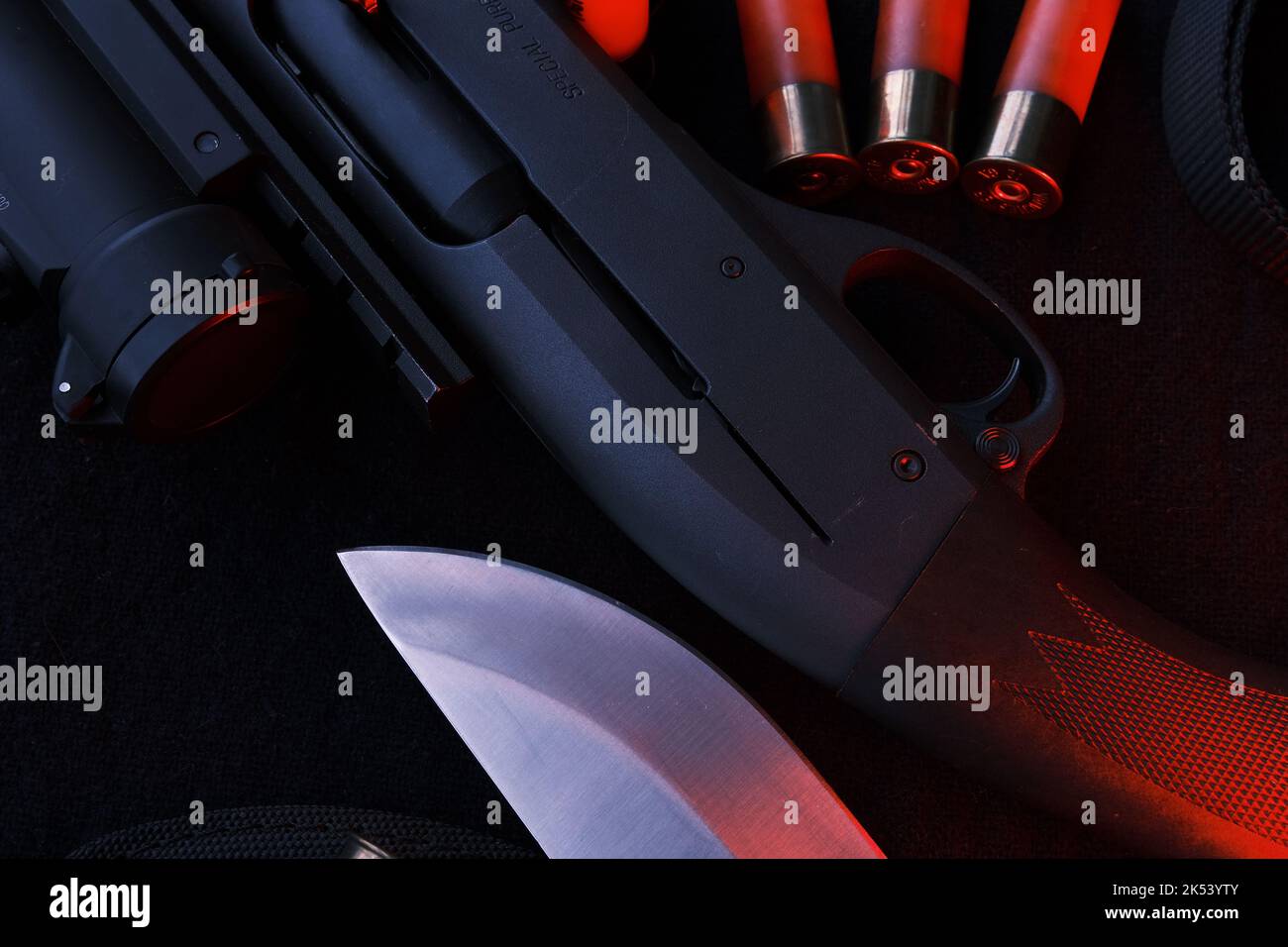 Weapon on black cloth: knife, rifle, shells,top view. Top view of knife ...