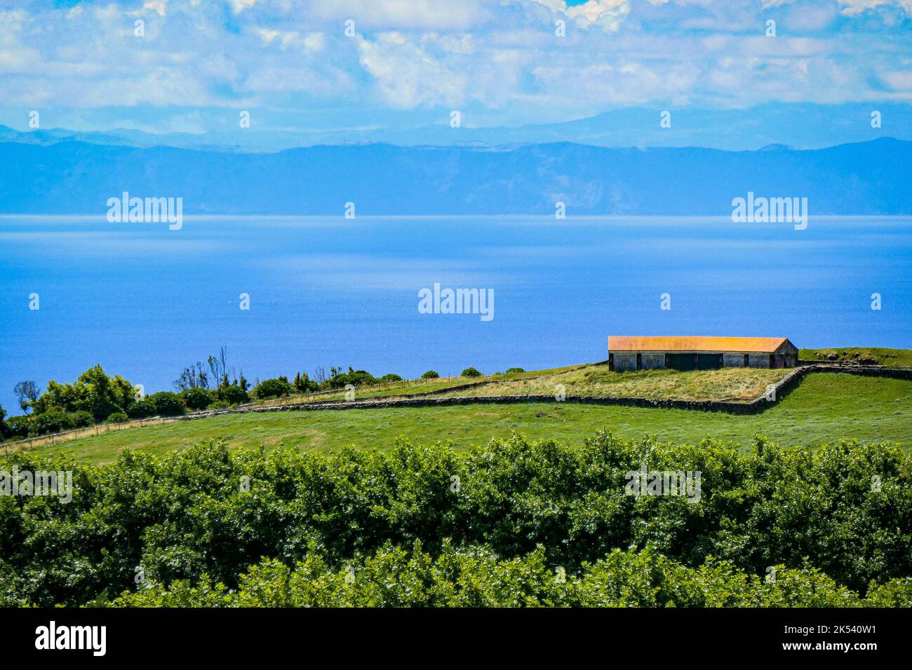 The coastline, showing the countryside and ocean of Graciosa Island ...