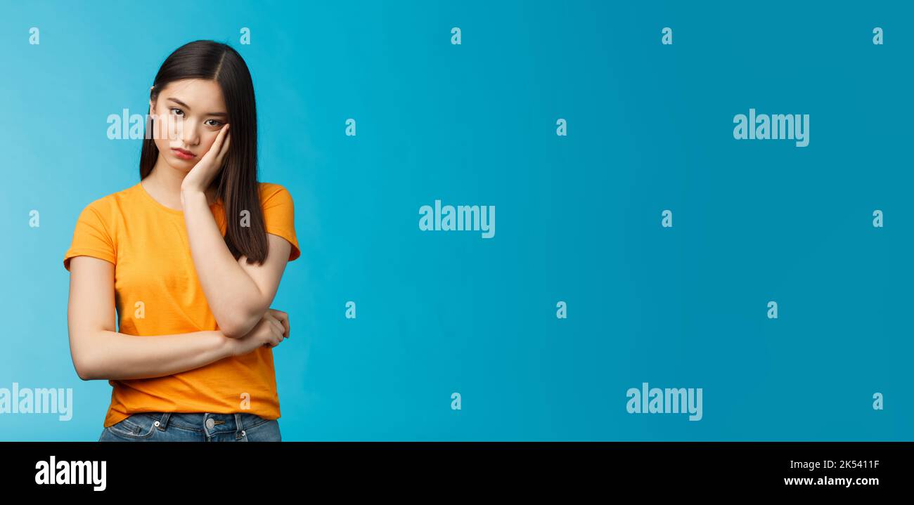 Sad bored asian female student attend boring uninteresting lecture lean ...