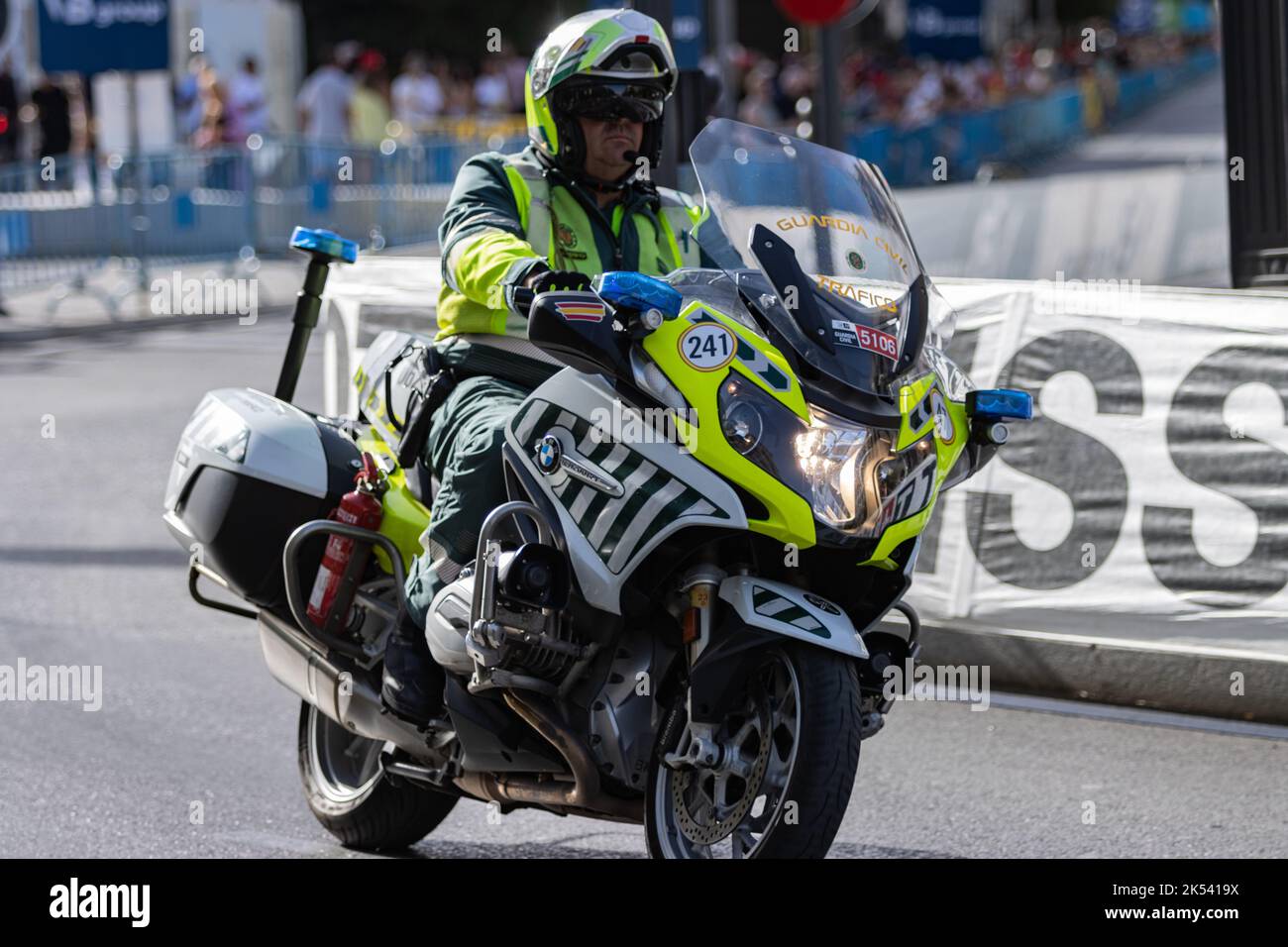 A male spanish civil guard on a motorcycle with a yellow uniform ...