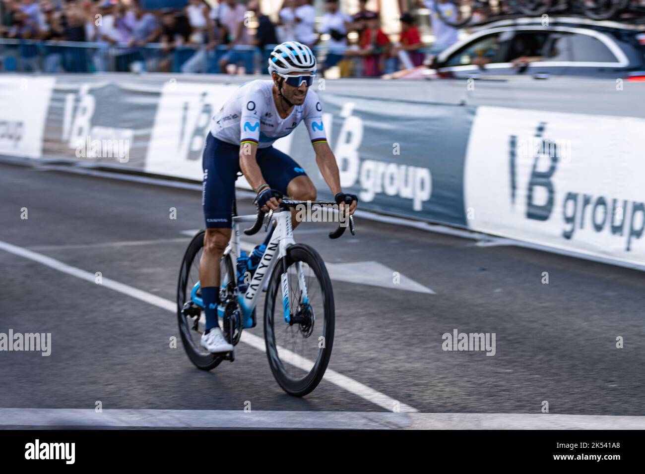 Spanish cyclist Alejandro Valverde riding through a paved road with ...
