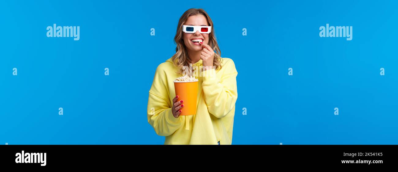 Leisure, fun and youth concept. Happy entertained smiling blond girl in ...