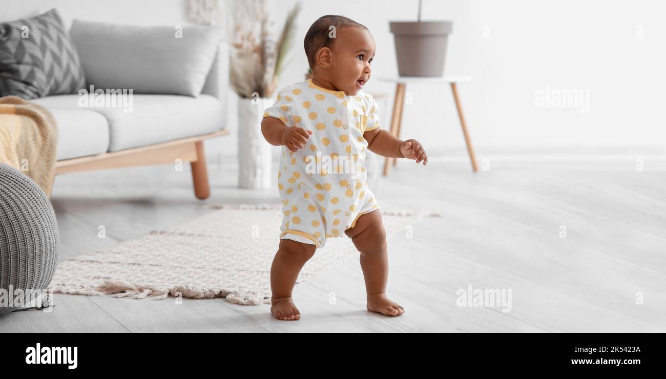 Cute little African-American baby learning to walk at home Stock Photo ...