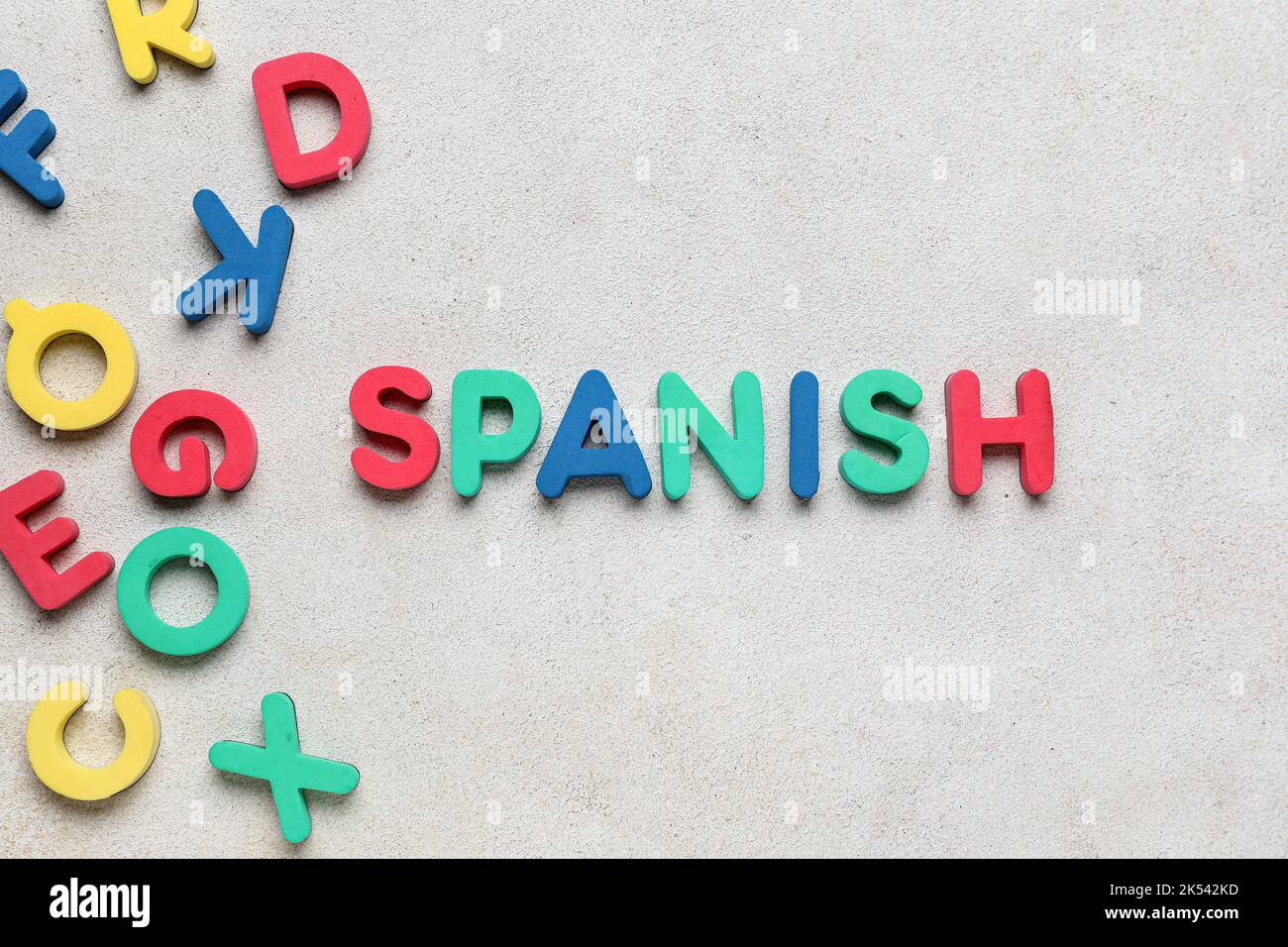 Word SPANISH with letters on grey background Stock Photo - Alamy