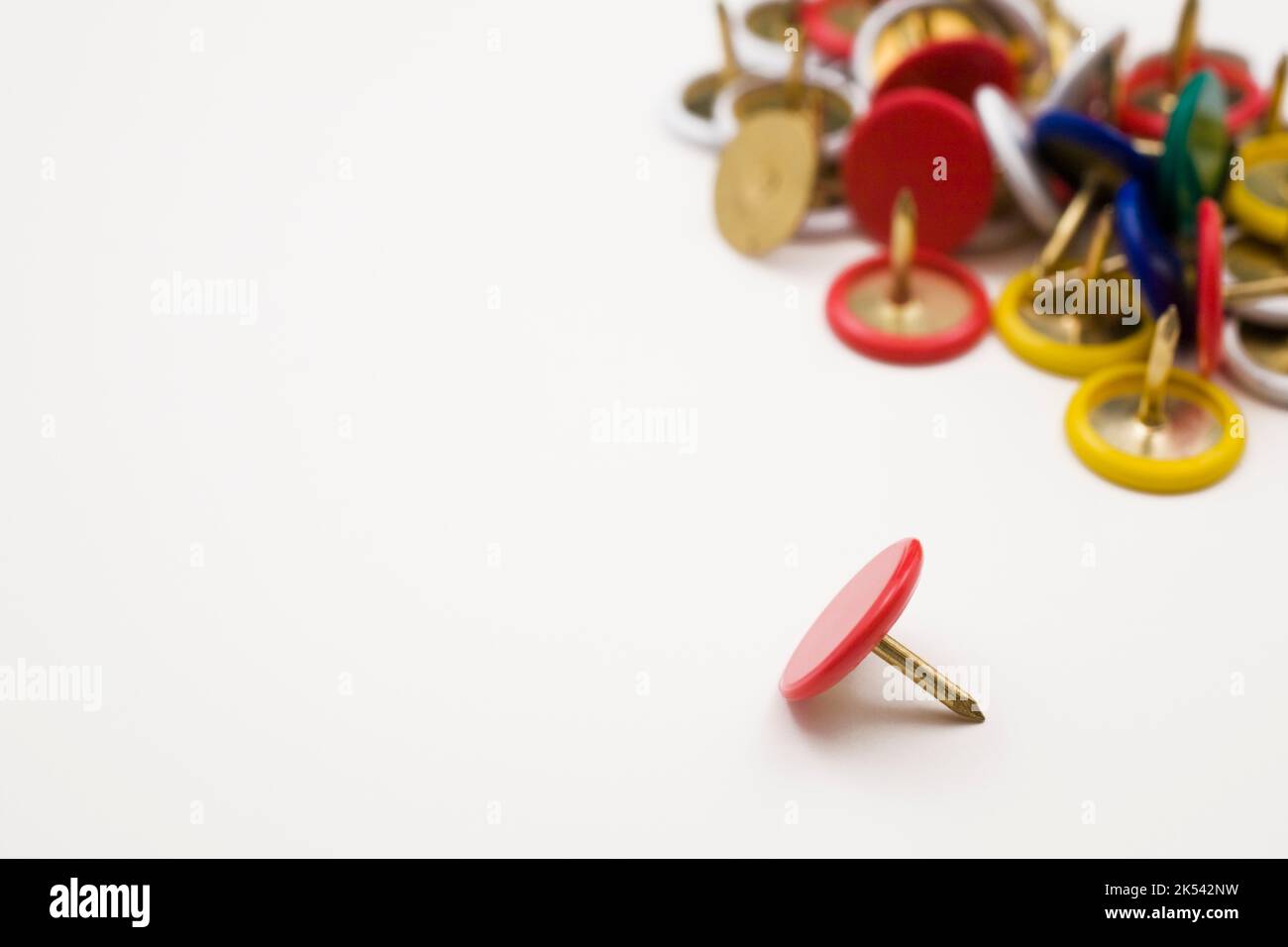 Thumbtacks on white background Stock Photo - Alamy
