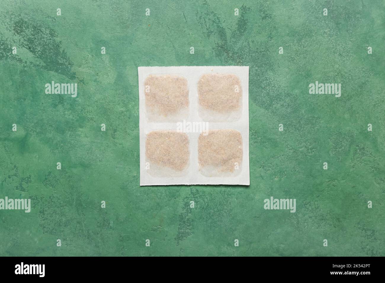 Mustard plaster on green background Stock Photo - Alamy