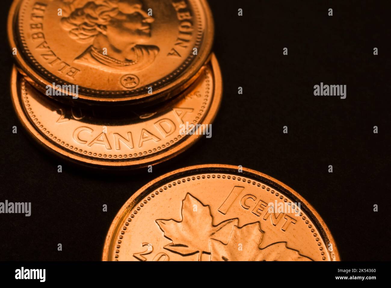 Canadian pennies on black background Stock Photo - Alamy