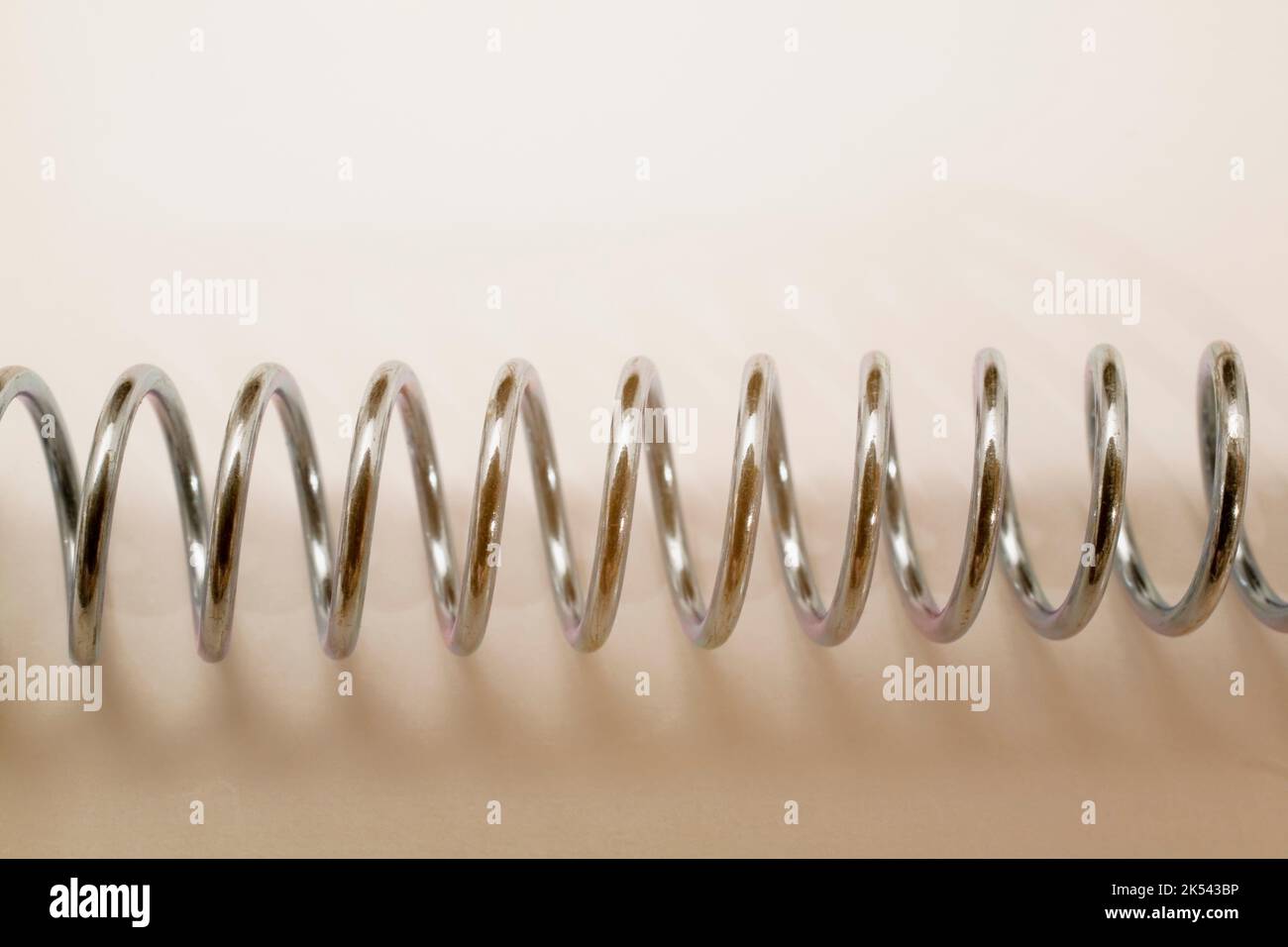 Metal spring on white background Stock Photo - Alamy