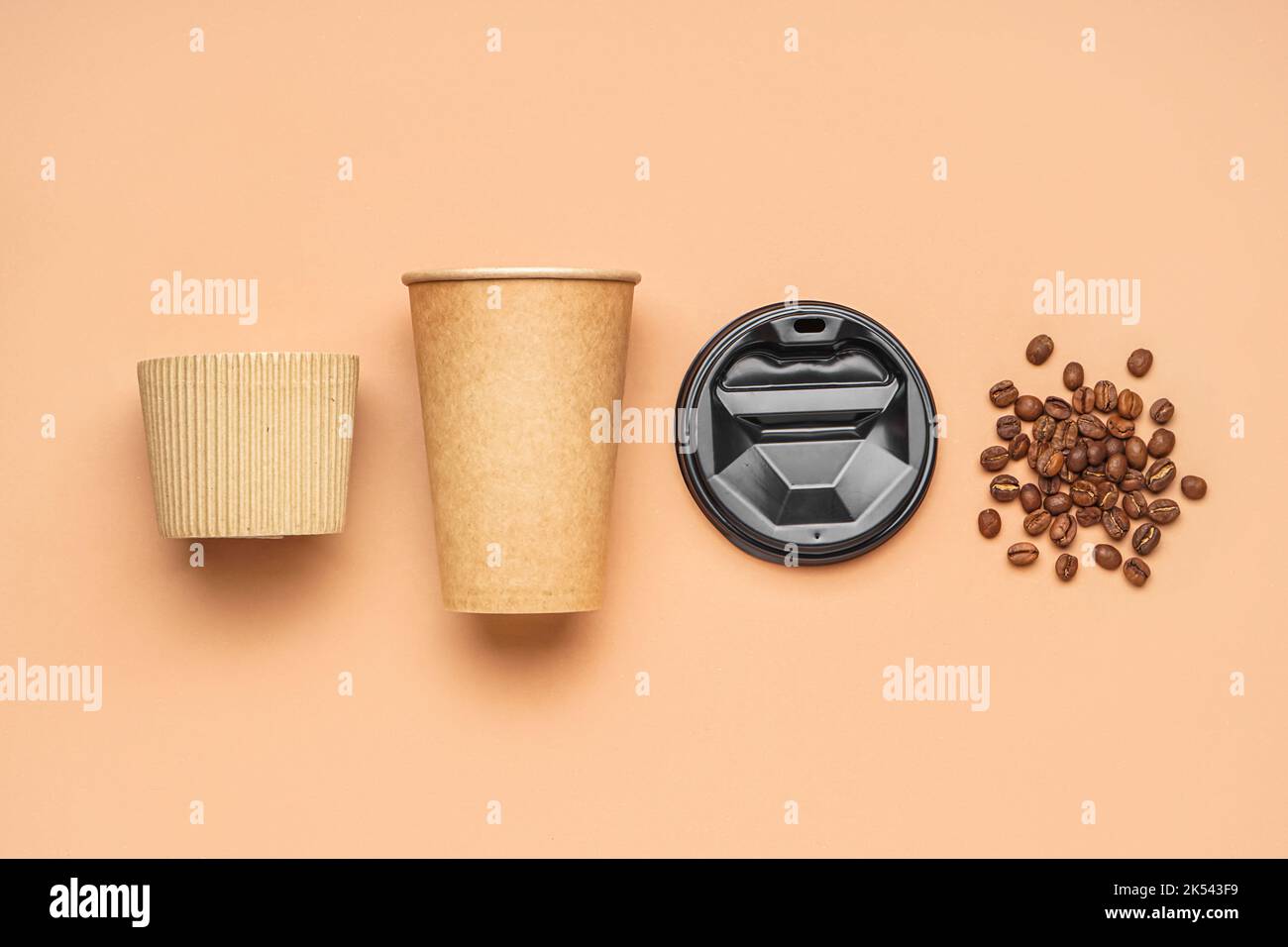 Paper cup, cap and coffee beans on color background Stock Photo - Alamy