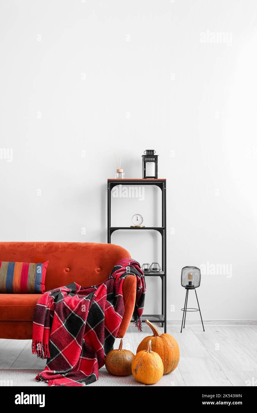 Autumn interior of living room with red sofa and shelving unit Stock ...