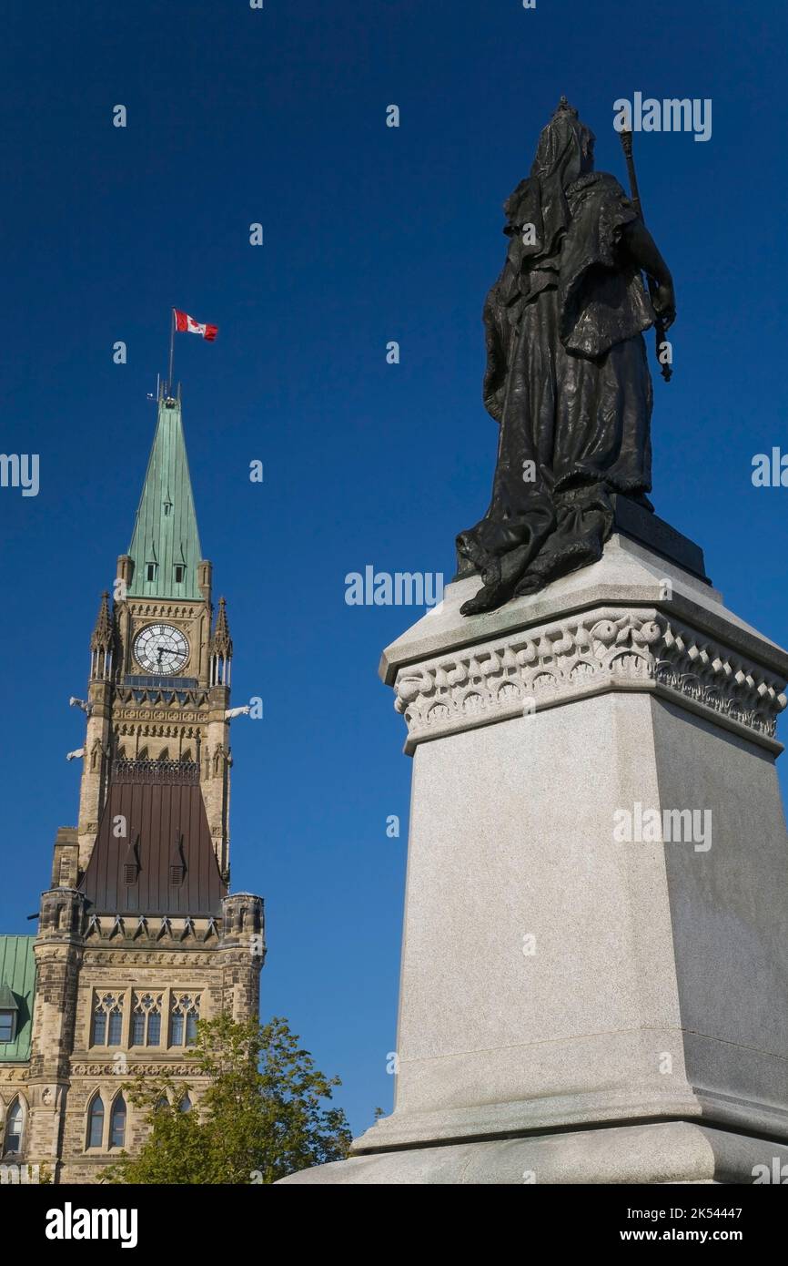 Partial view of Peace Tower and Queen Victoria statue on Parliament ...