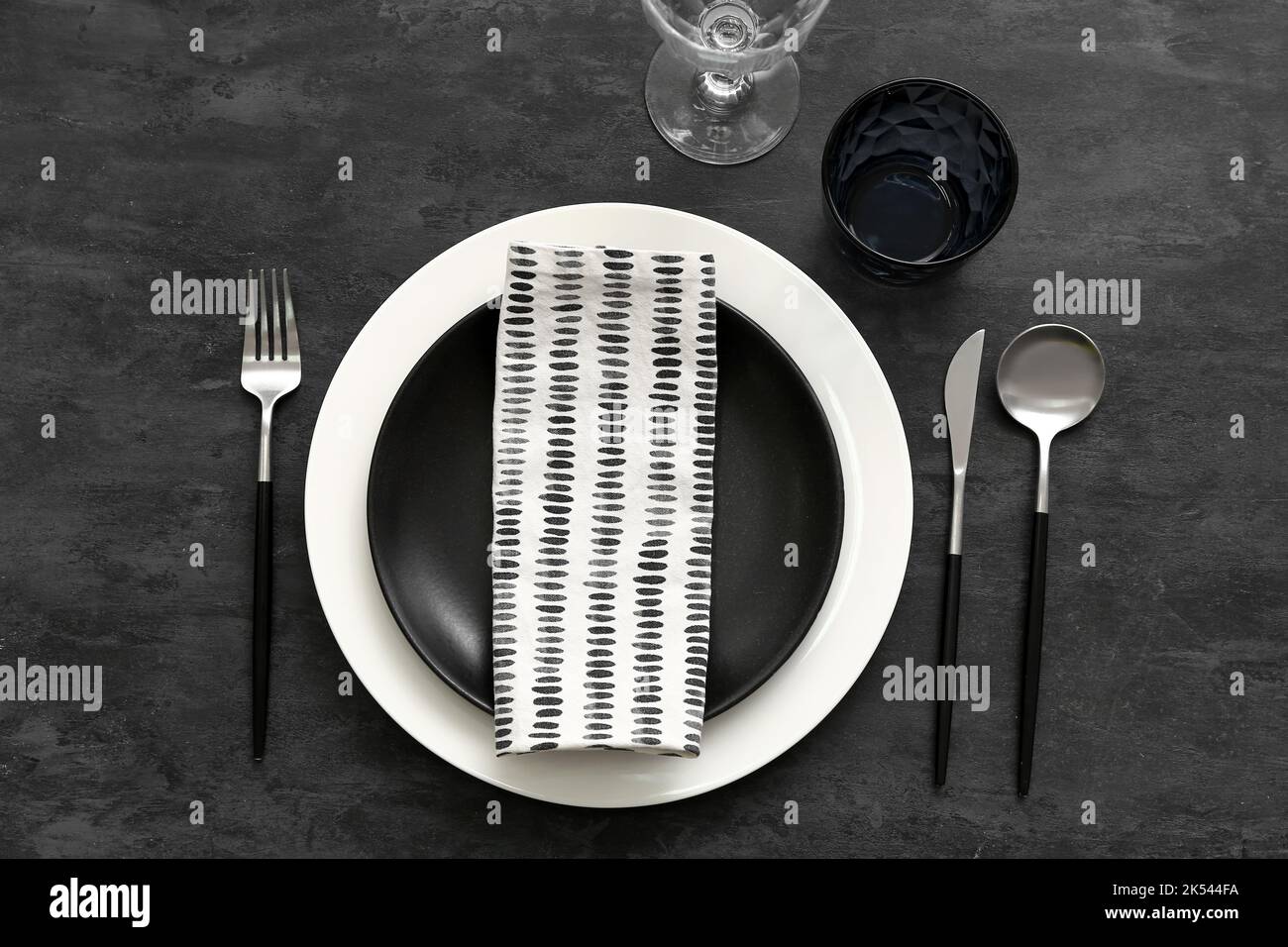 Stylish table setting on black background Stock Photo - Alamy