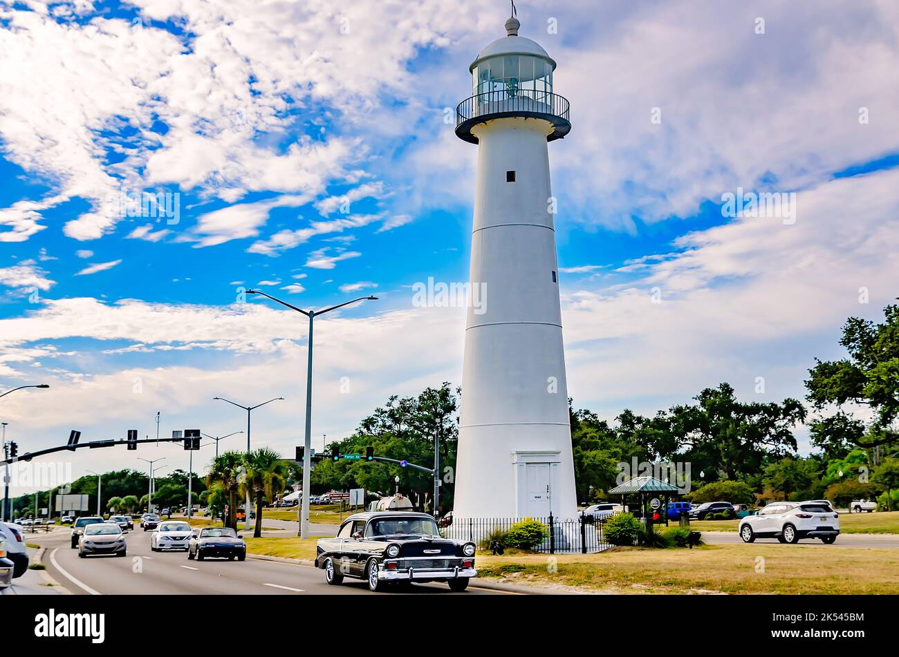 A vintage Chevrolet automobile passes the Biloxi lighthouse during the ...