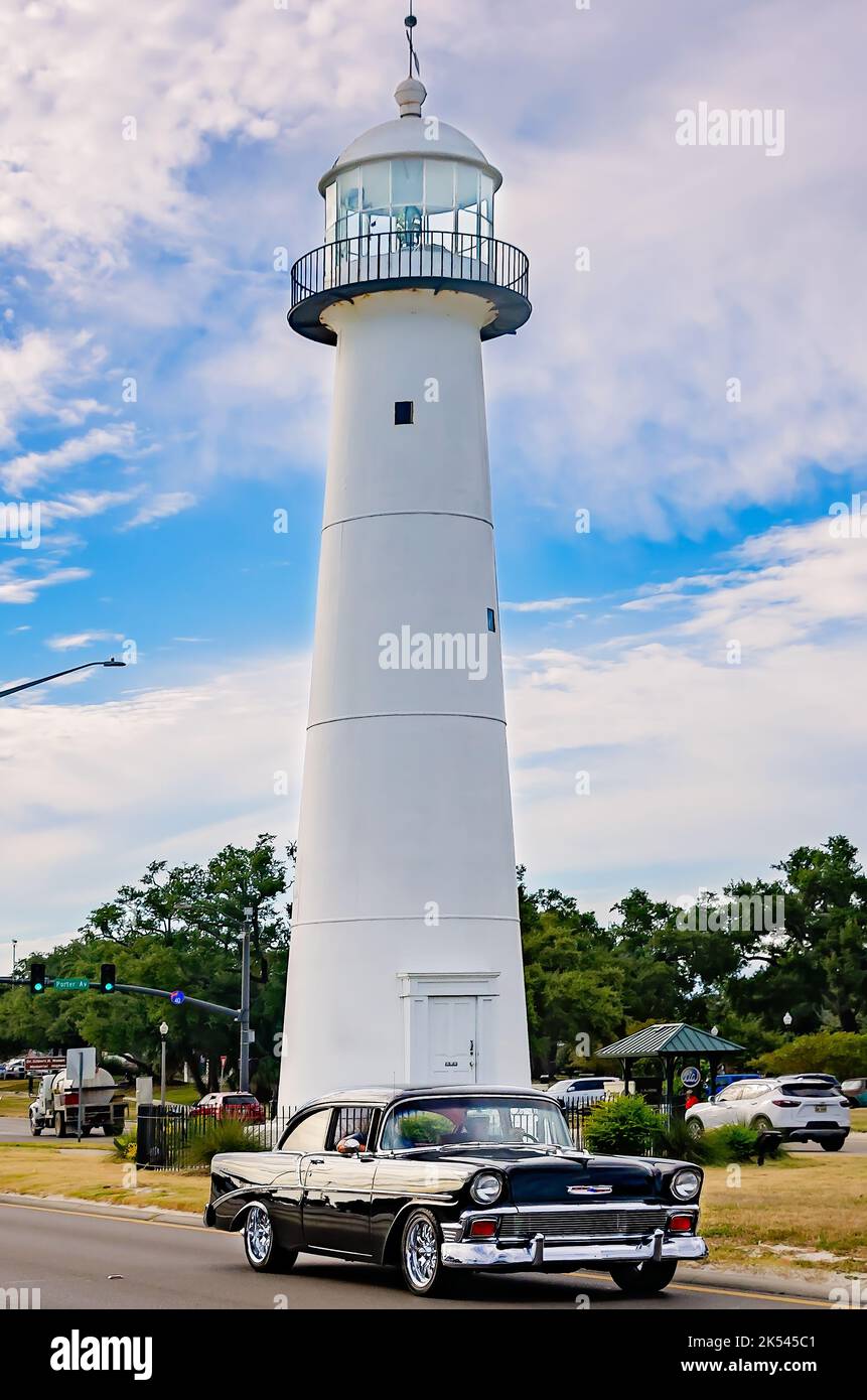A vintage Chevrolet automobile passes the Biloxi lighthouse during the ...