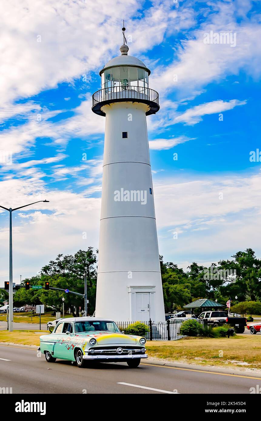 A vintage automobile passes the Biloxi lighthouse during the 26th ...