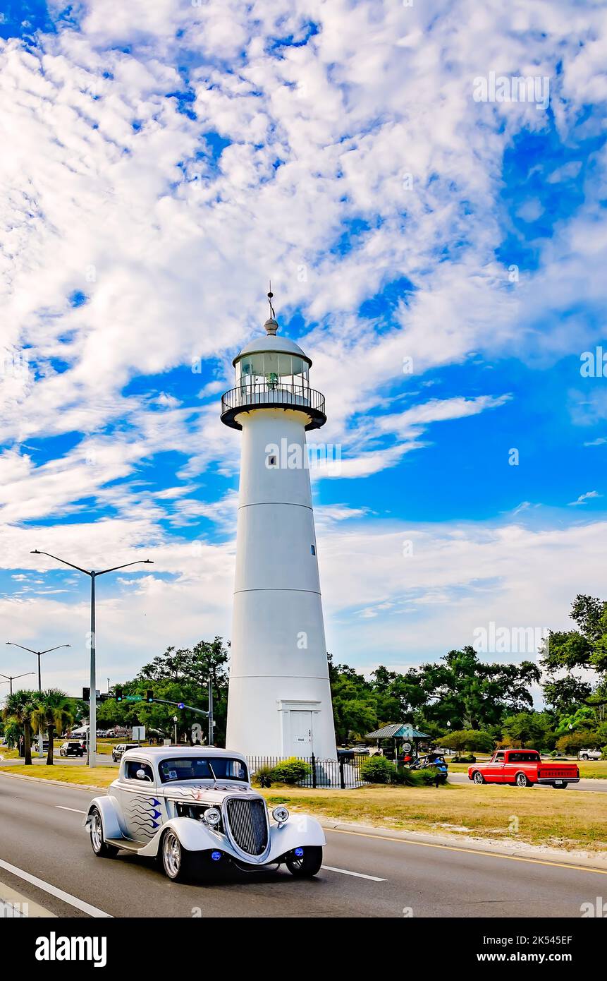 A vintage automobile passes the Biloxi lighthouse during the 26th ...
