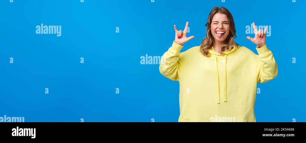 Let us have fun. Carefree joyful good-looking blonde female in yellow ...