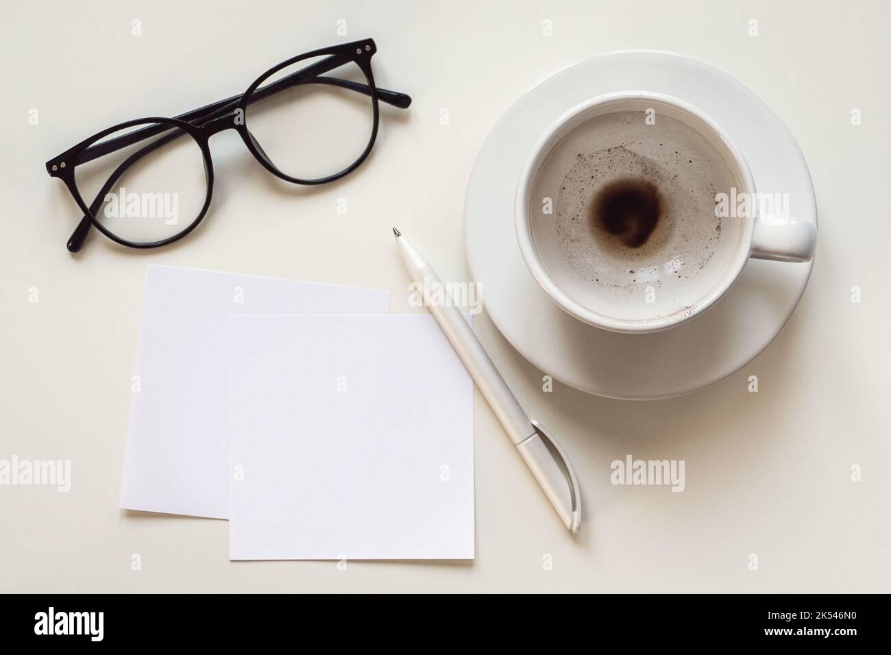 Paper notes mockup, blank space, empty coffee cup, eyeglasses and pen ...