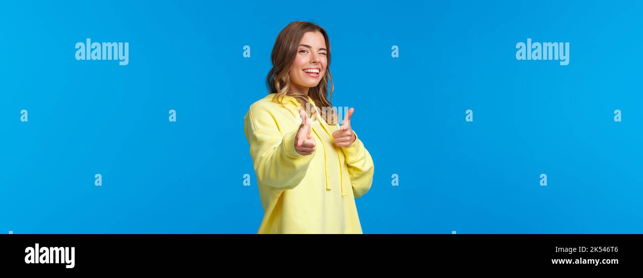Hey you. Cheeky and carefree cute modern european girl in yellow hoodie ...