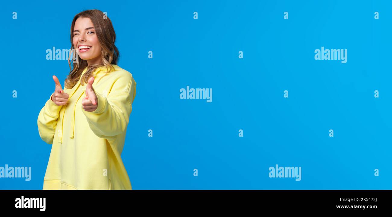 Hey you. Cheeky and carefree cute modern european girl in yellow hoodie ...