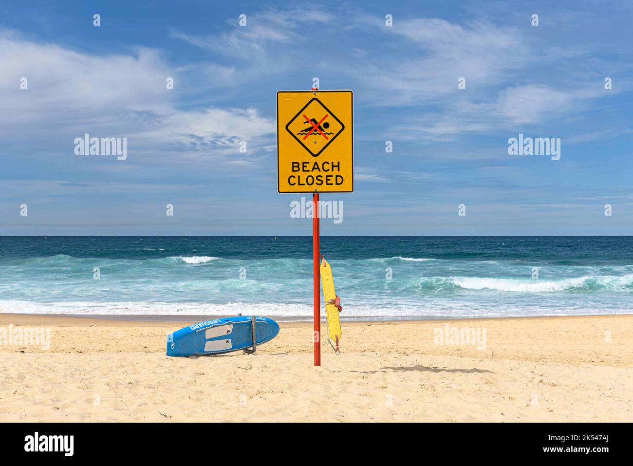 A beach closed sign and Kracka lifeguard board at Maroubra Beach ...