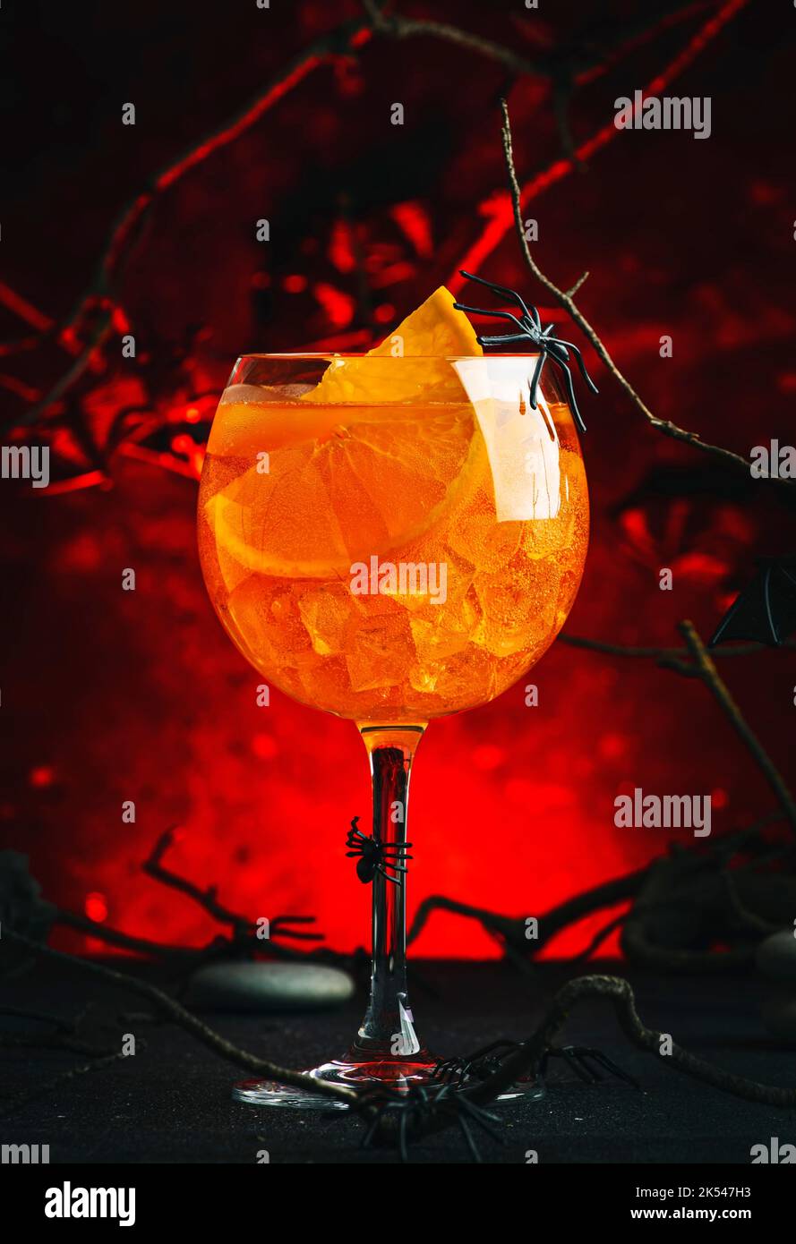Halloween aperol spritz cocktail on scary dark bloody red background ...