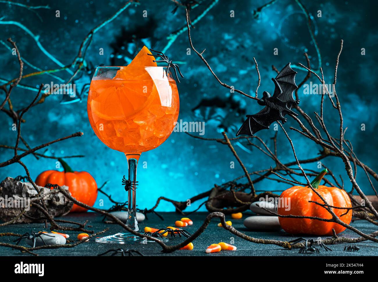 Halloween aperol spritz cocktail on scary dark blue background with ...