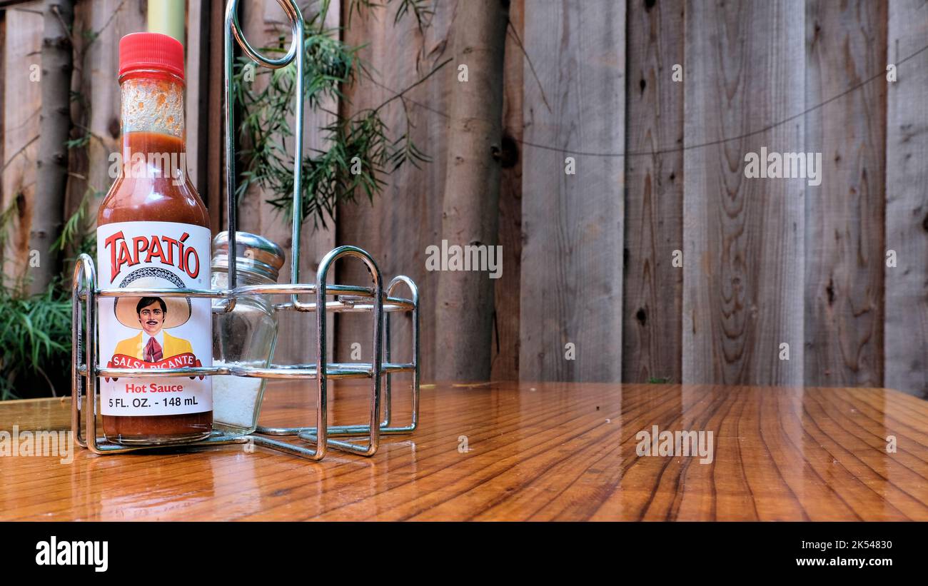 Tapatio hot sauce bottle and salt shaker in a metal condiment caddy on ...