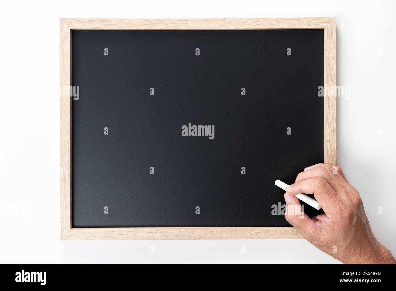 Blank blackboard or chalkboard with hand holding chalk Stock Photo - Alamy