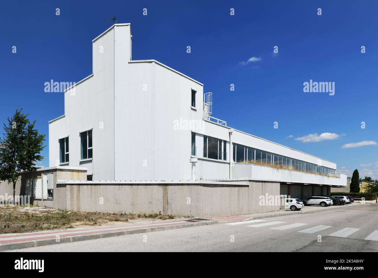 Facade of a lonely industrial building with white cladding, many ...