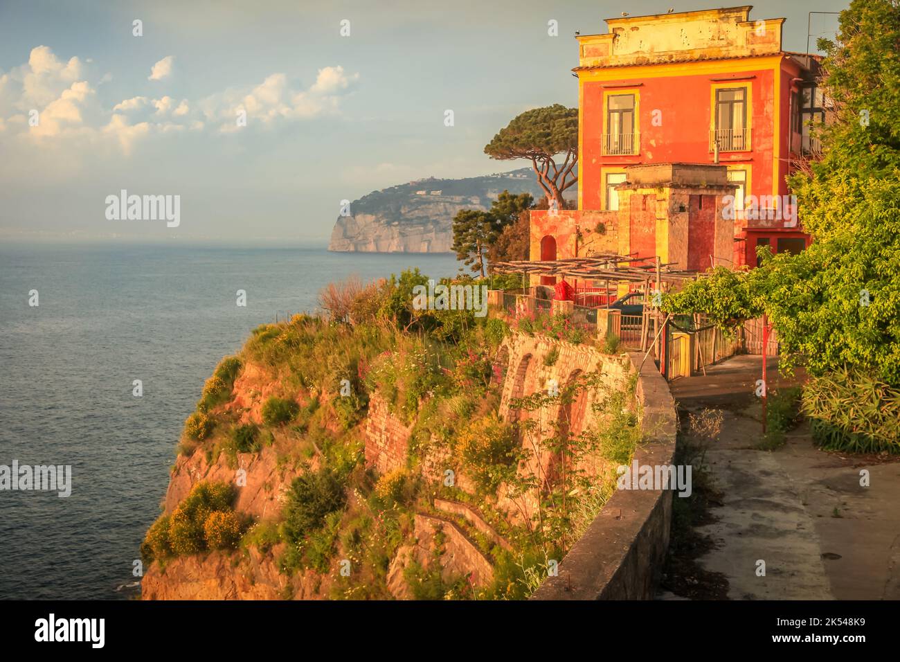 Sorrento cityscape above cliffs at golden sunset, Gulf of Naples ...