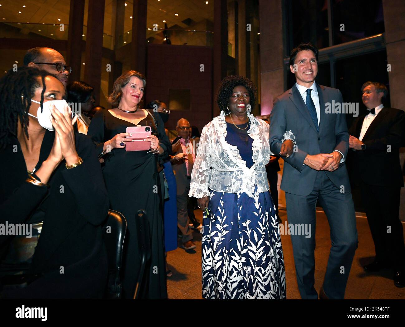 Prime Minister Justin Trudeau walks with Jean Augustine, who became the ...