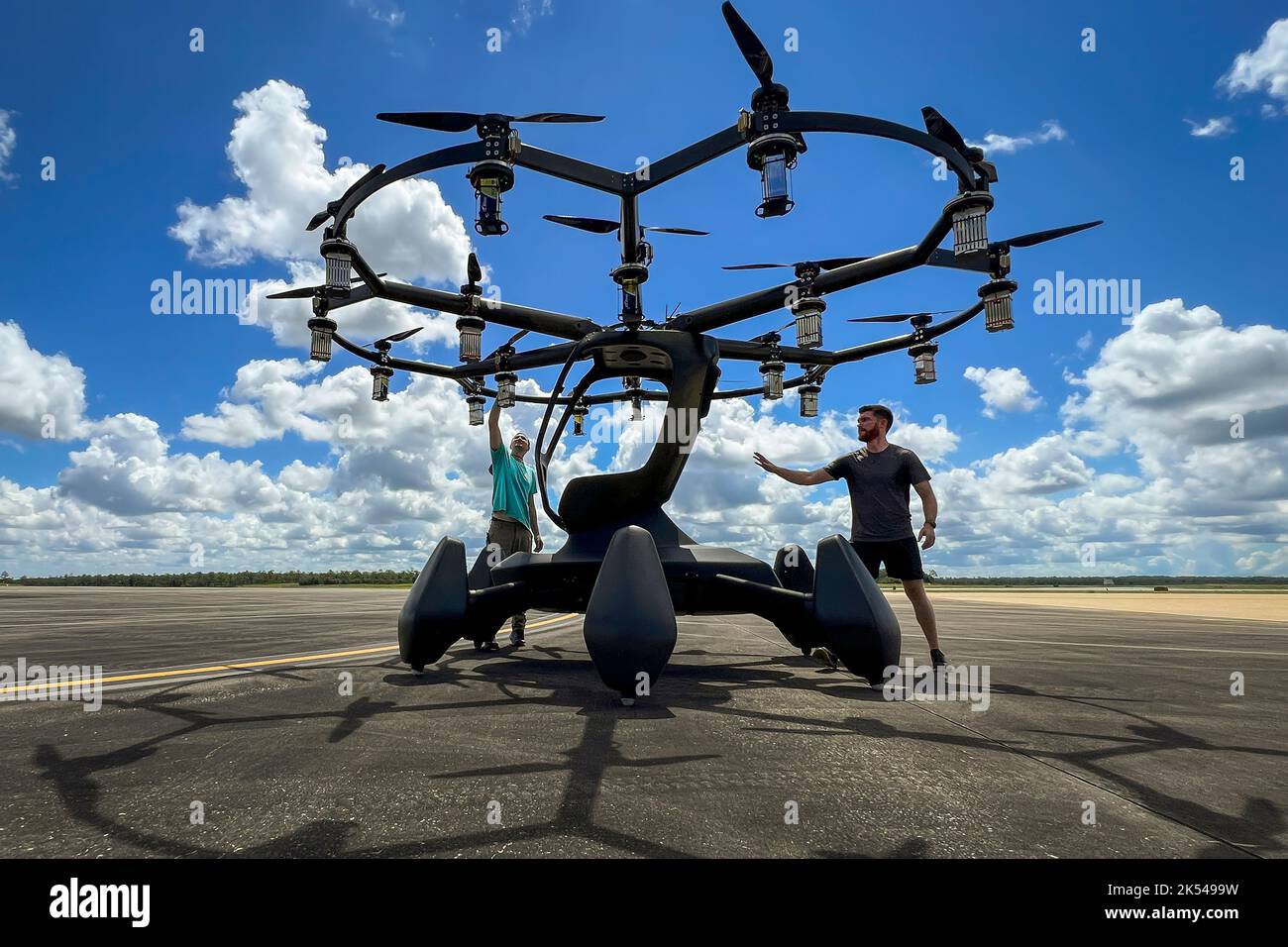 LIFT team members secure batteries to the Hexa aircraft’s motors before ...