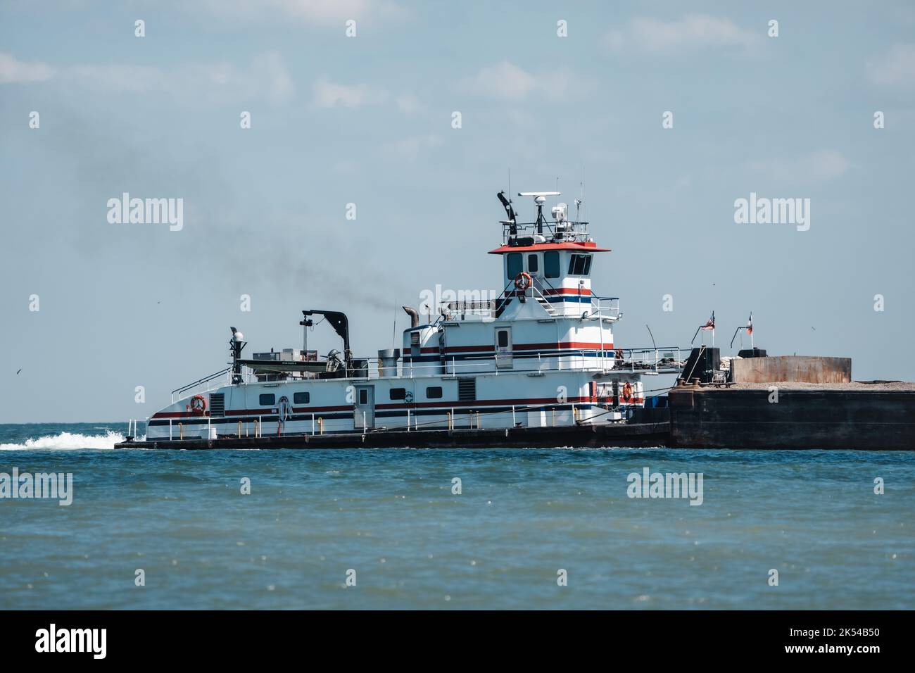 boat pusing dirt at gulf of mexico Stock Photo - Alamy