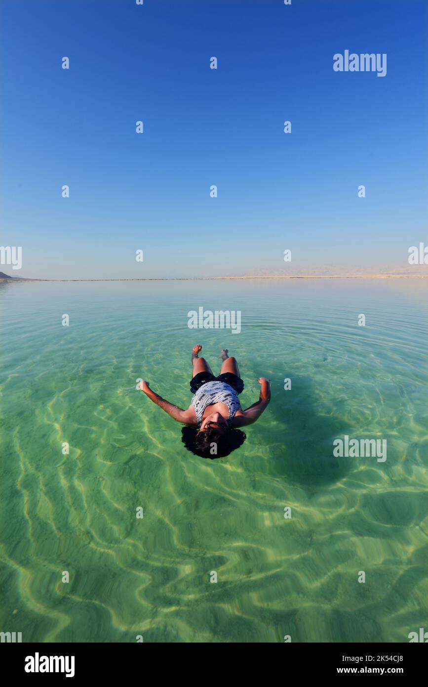 Floating on the salty water of the Dead Sea in Israel Stock Photo - Alamy