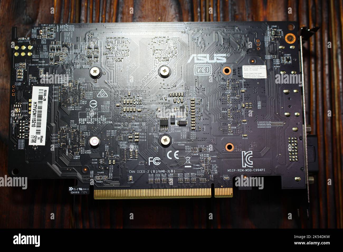 The back side of the Asus AMD Radeon RX550 graphics card lying on the ...