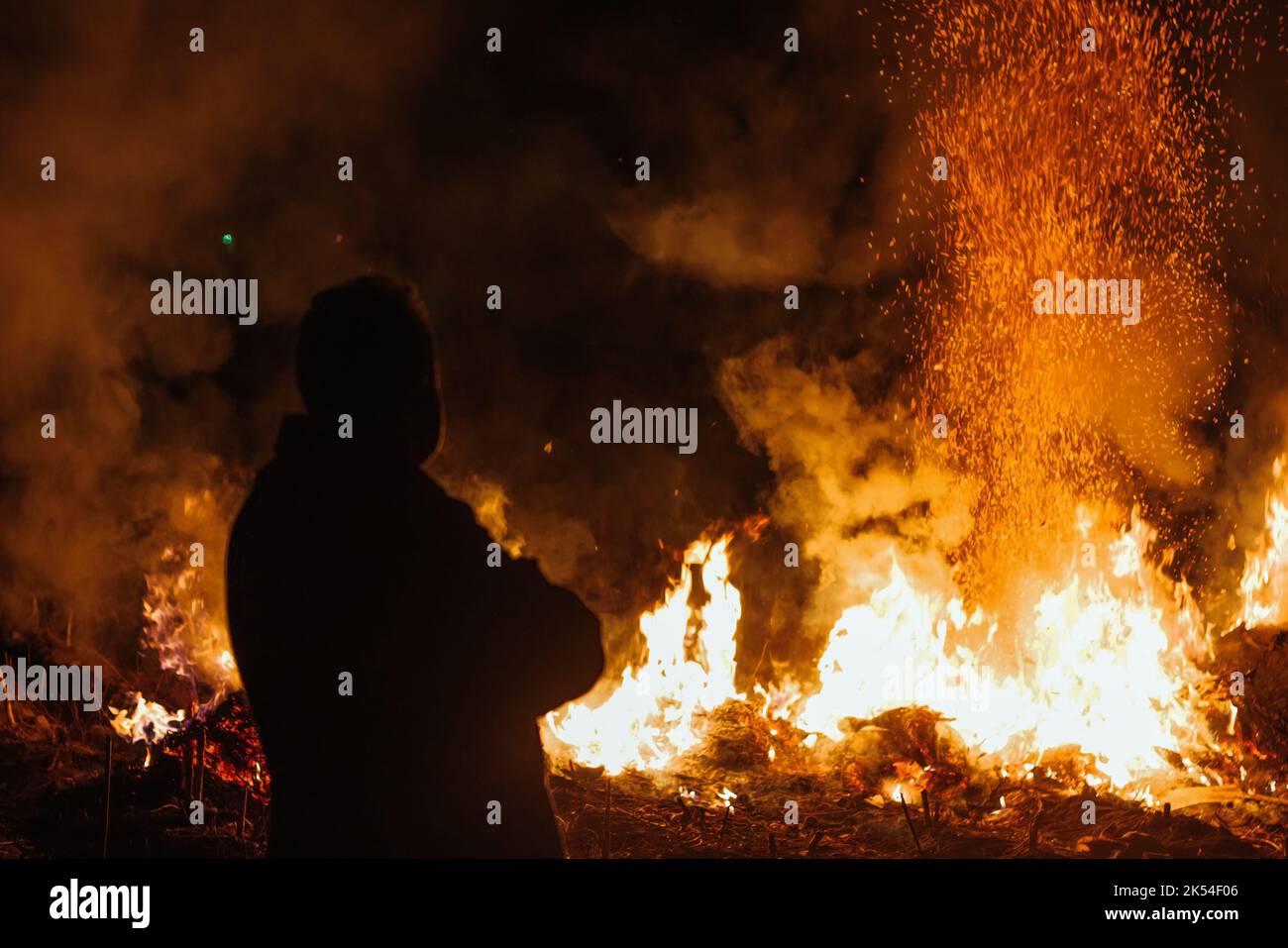 A Silhouette man stand in front of fire Stock Photo - Alamy