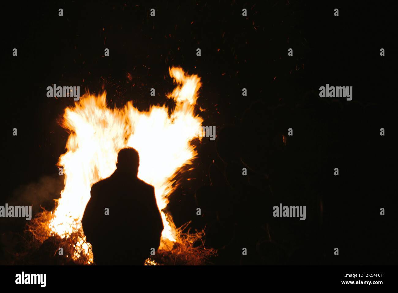 A Silhouette man stand in front of fire Stock Photo - Alamy